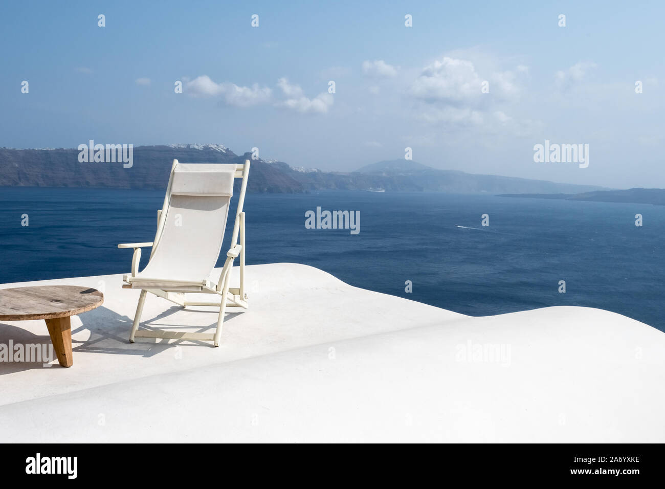 a Oia rooftop deck chair on white waveform curved shape roof with ...
