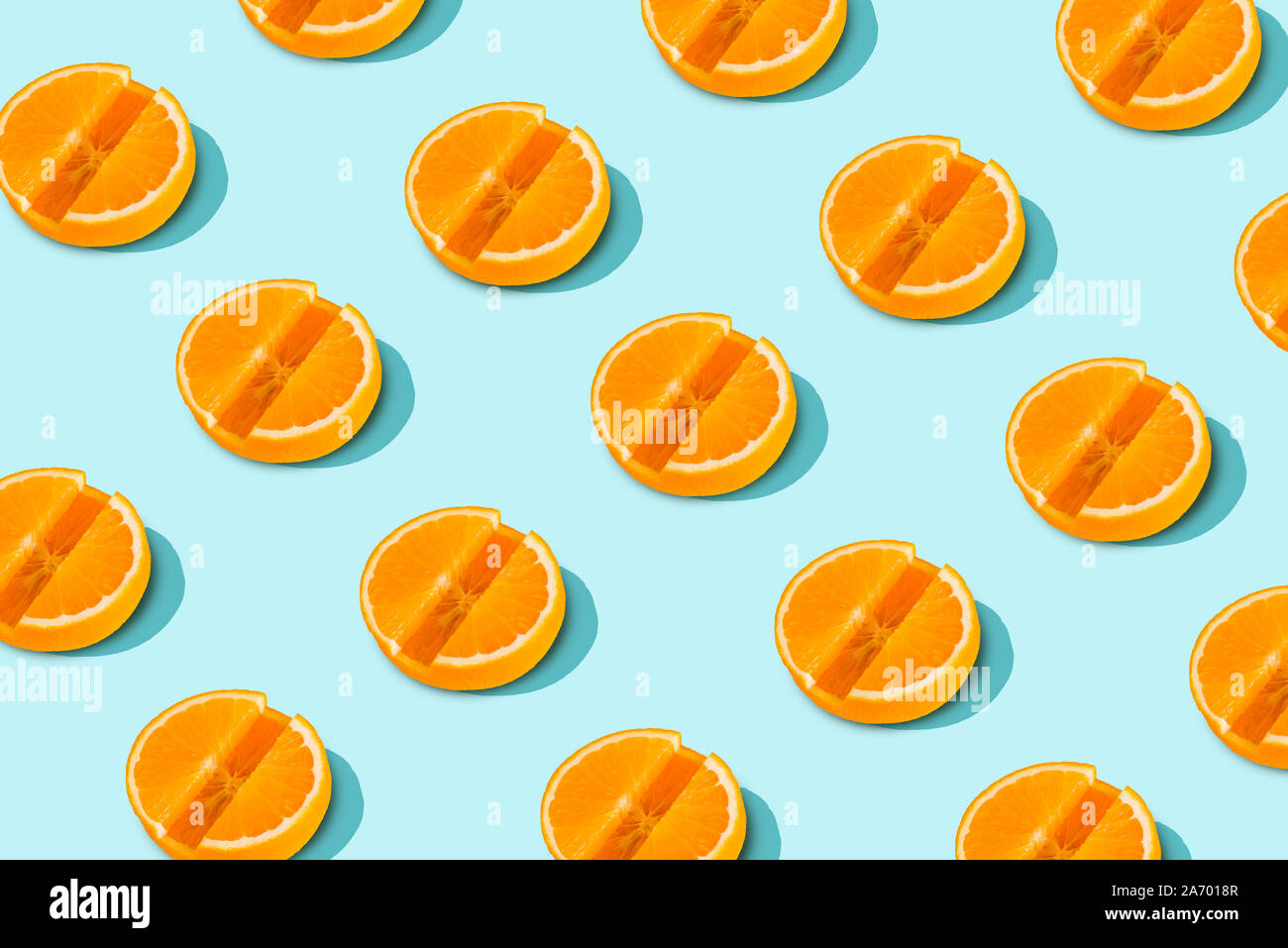 Vitamin C pattern of orange slices in the form of tablets on light blue ...