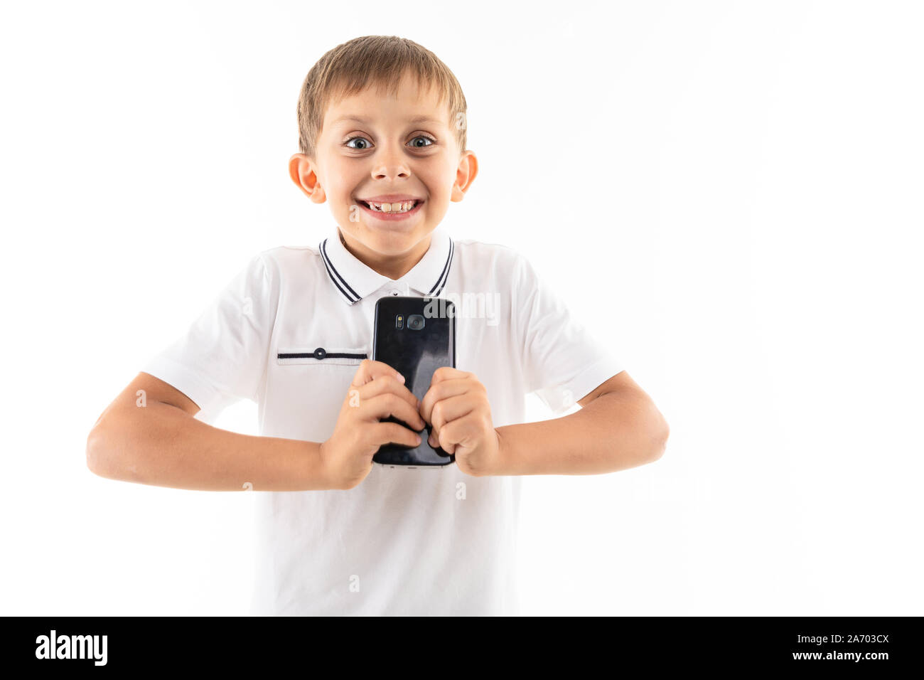 happy boy with a phone in his hands smiling with teeth, photograph of a ...