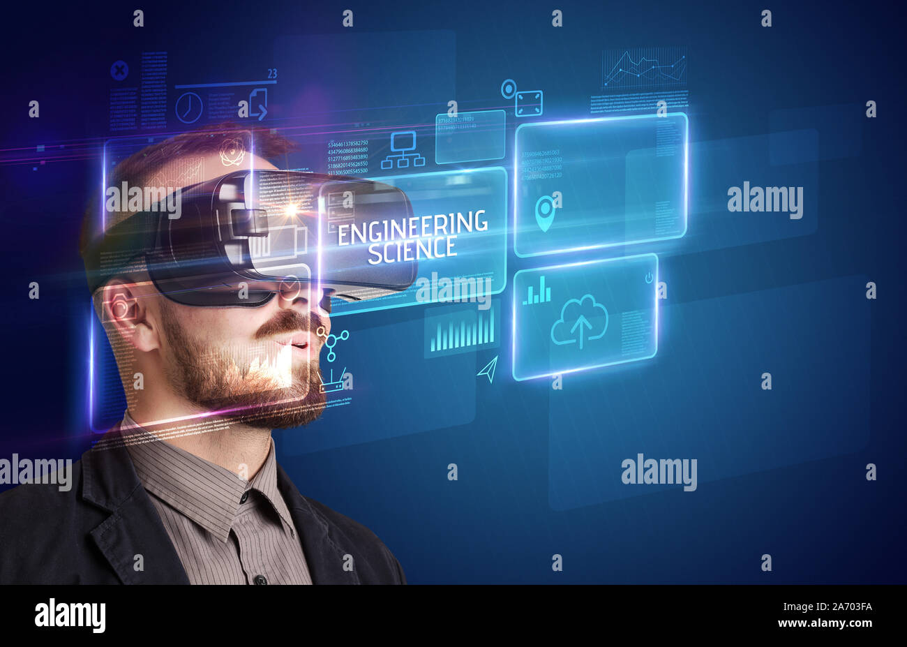Businessman looking through Virtual Reality glasses with ENGINEERING ...