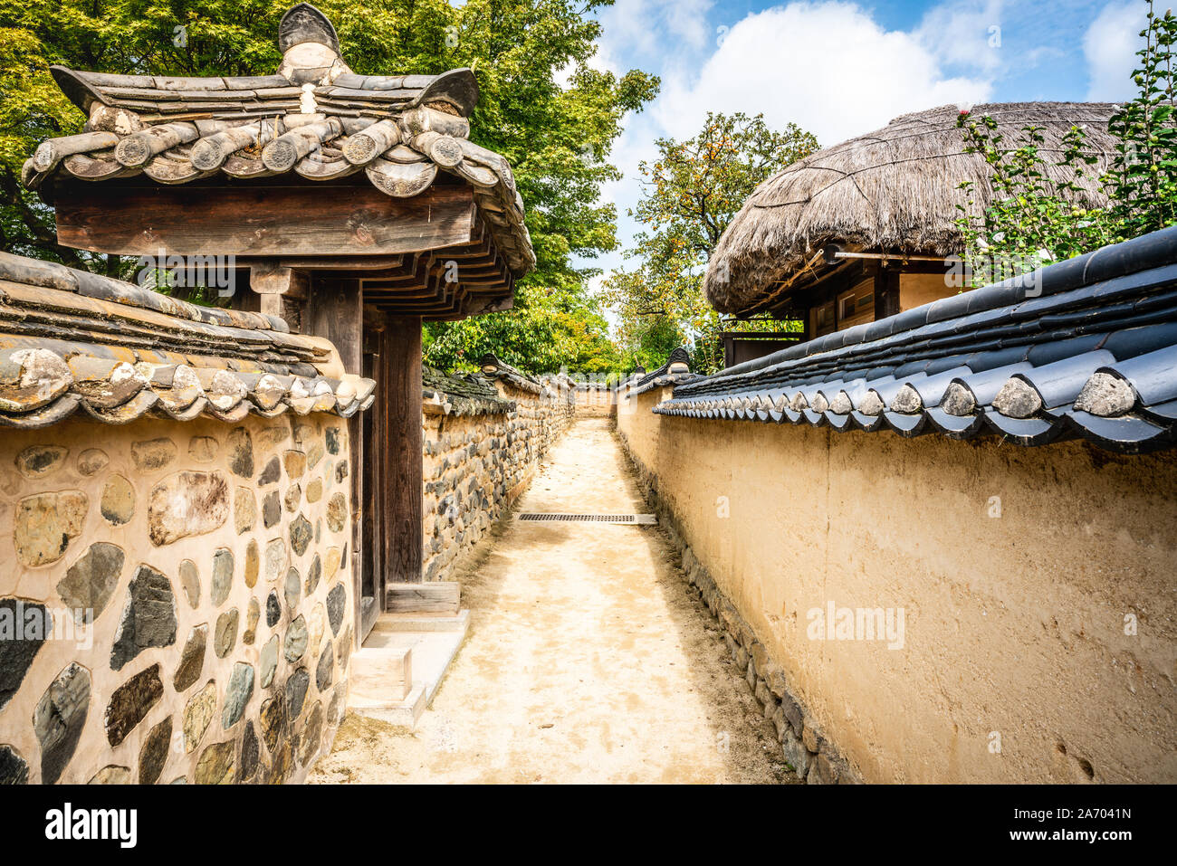 Alley with houses walls and gates in historic Hahoe folk village in ...