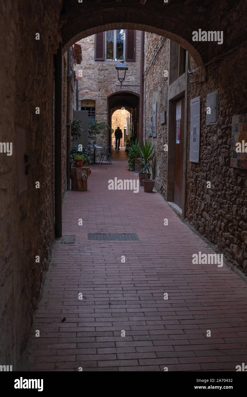 The empty narrow winding back street of a historic hilltop town in ...