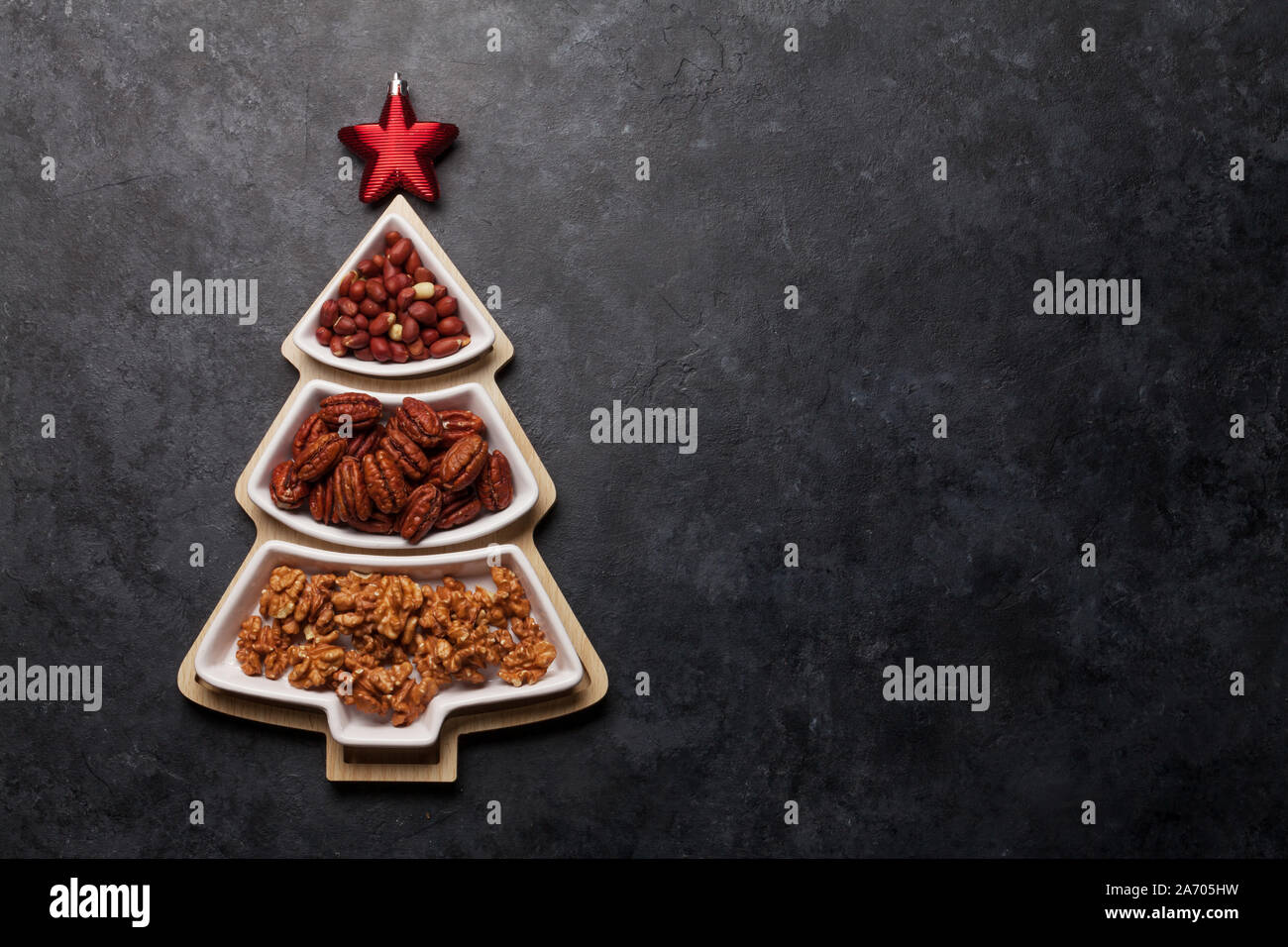 Christmas greeting card with various nuts in fir tree shaped box and ...