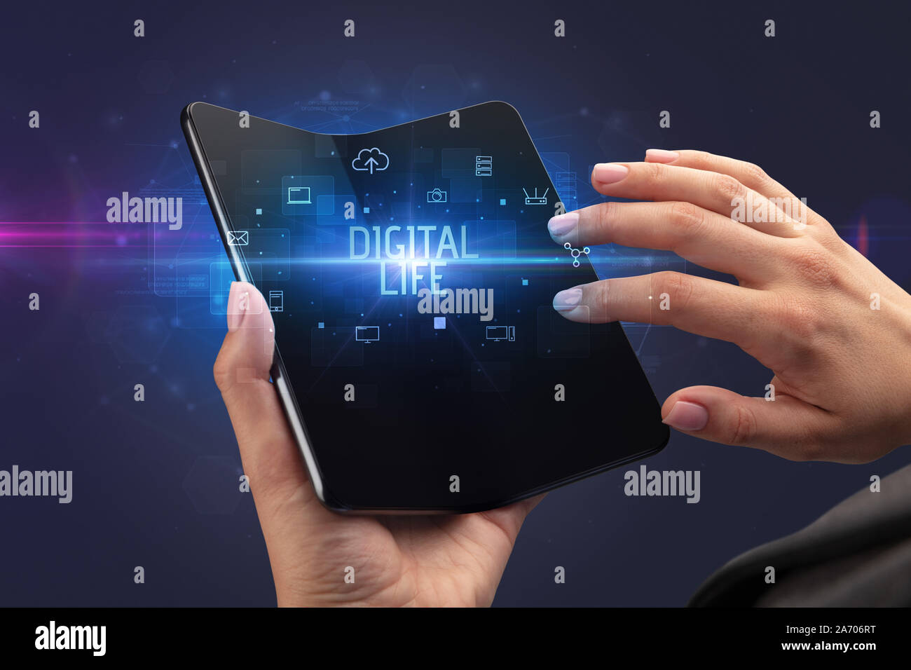Businessman holding a foldable smartphone with DIGITAL LIFE inscription ...