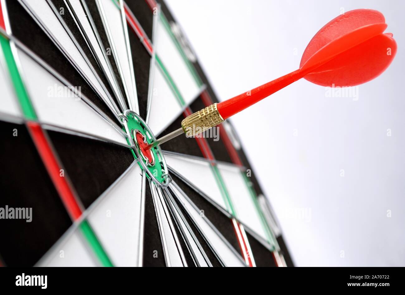 darts arrows in the target center Stock Photo - Alamy