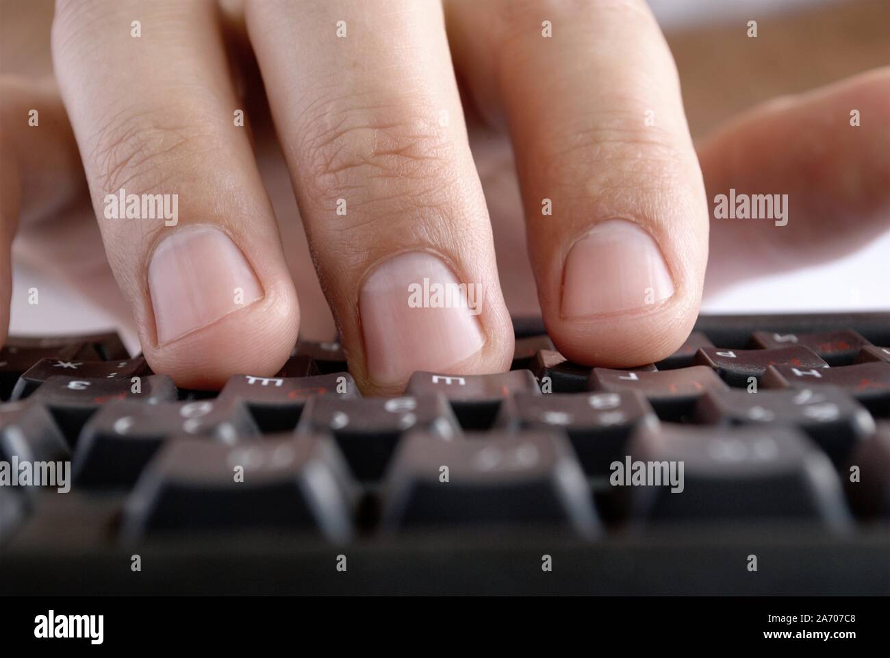 man's hand on computer keyboard woman's hand on the keyboard typing ...