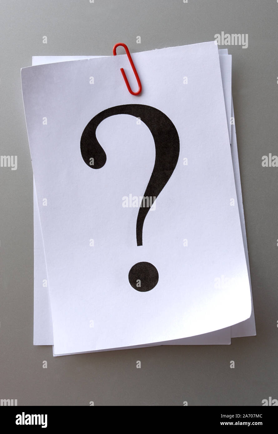 question mark on a piece of paper and red paper clip Stock Photo - Alamy