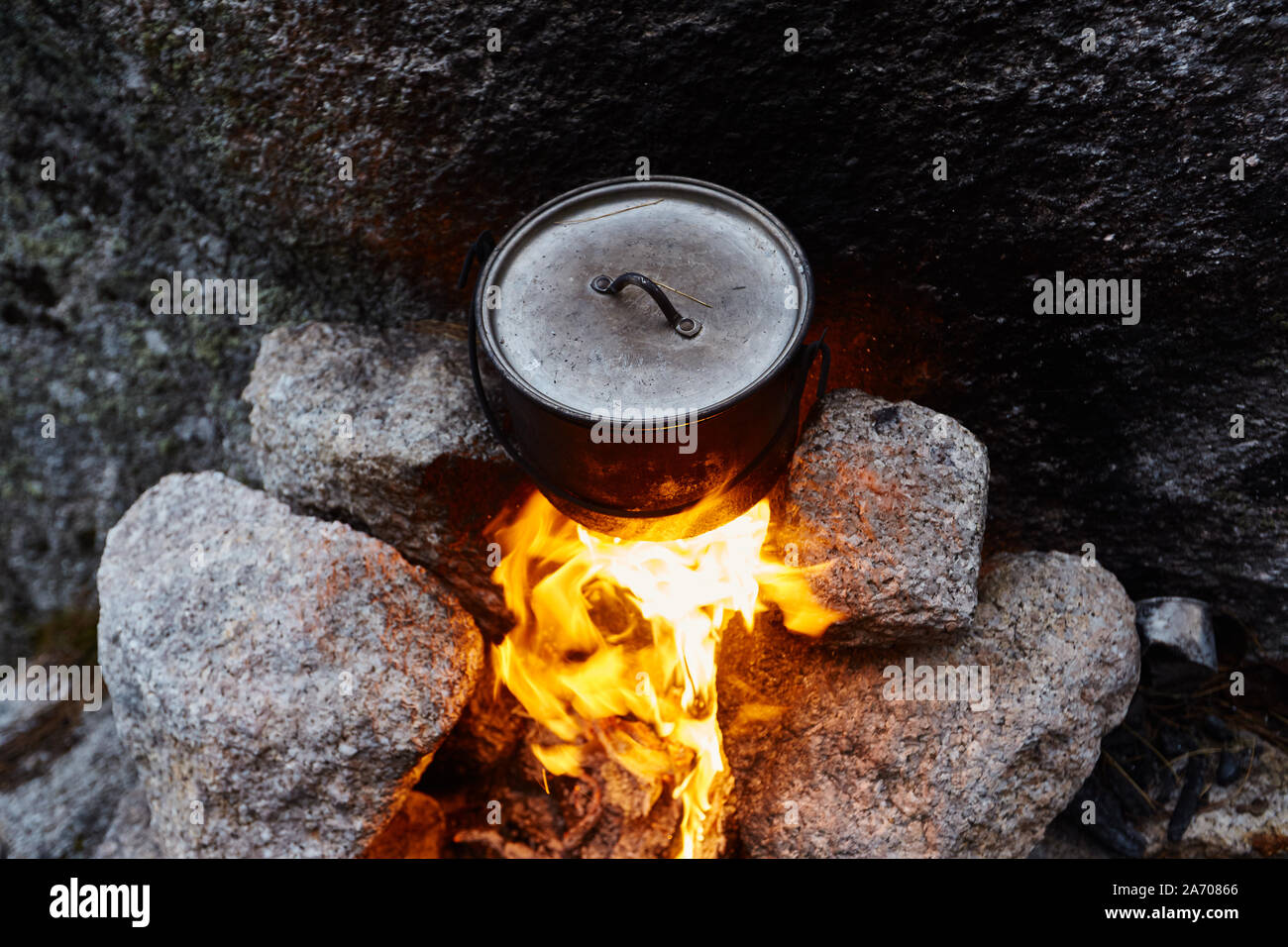 Man built a campfire in the woods in nature. Survive in the mountains ...