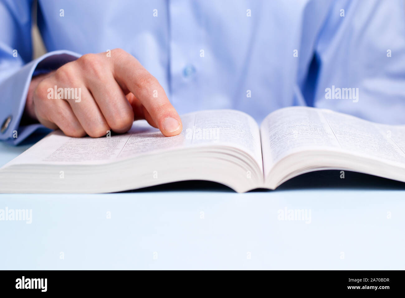 man reading a book, shows a close-up hand and a book Stock Photo - Alamy