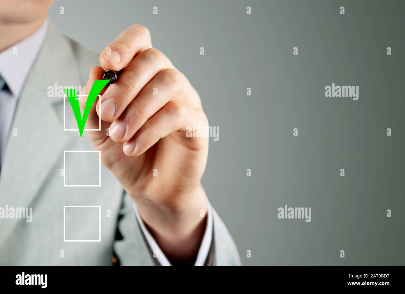 man in a business suit, put a check as a sign of quality Stock Photo ...