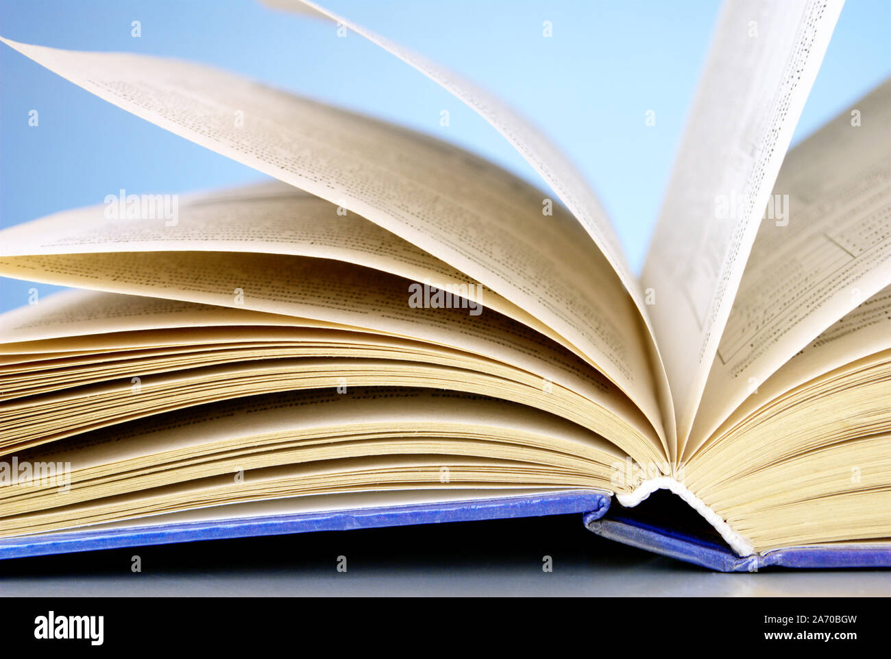 An open book on a blue gradient background Stock Photo - Alamy