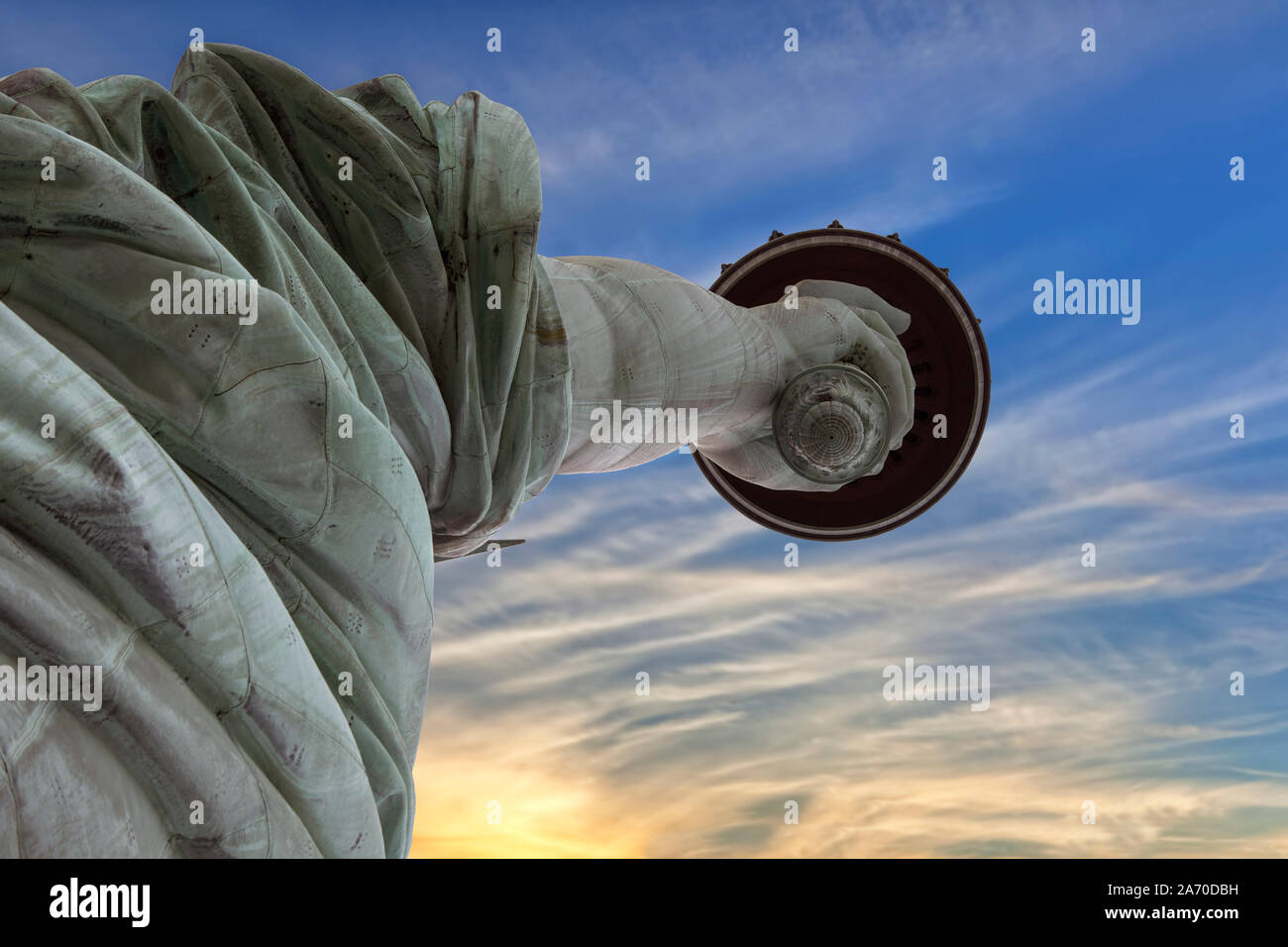 Extreme close up of hand and torch of Statue of Liberty at sunrise ...