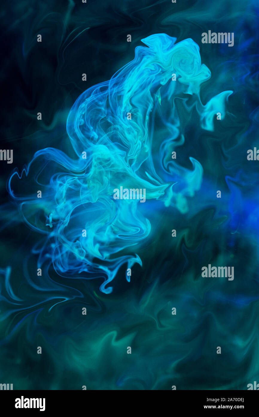 Artistic background with blue ink diffusion in liquid Stock Photo - Alamy