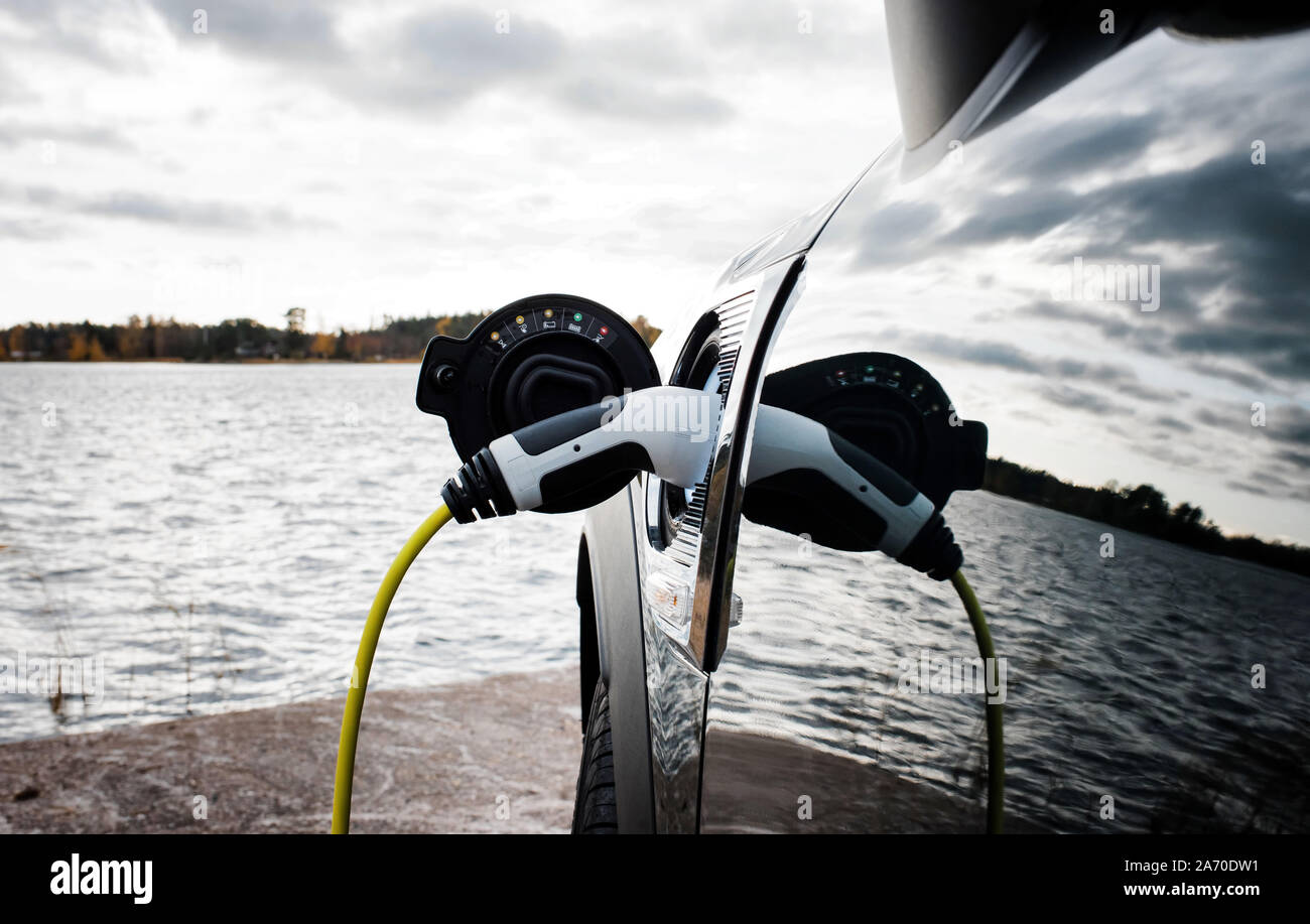Mini electric car charging socket and lead by the beach Stock Photo - Alamy