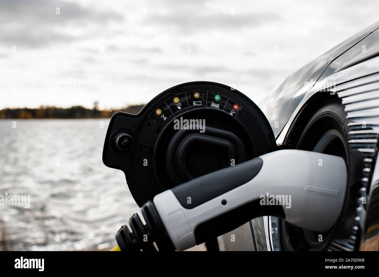 Electric car charging socket and lead by the beach Stock Photo - Alamy