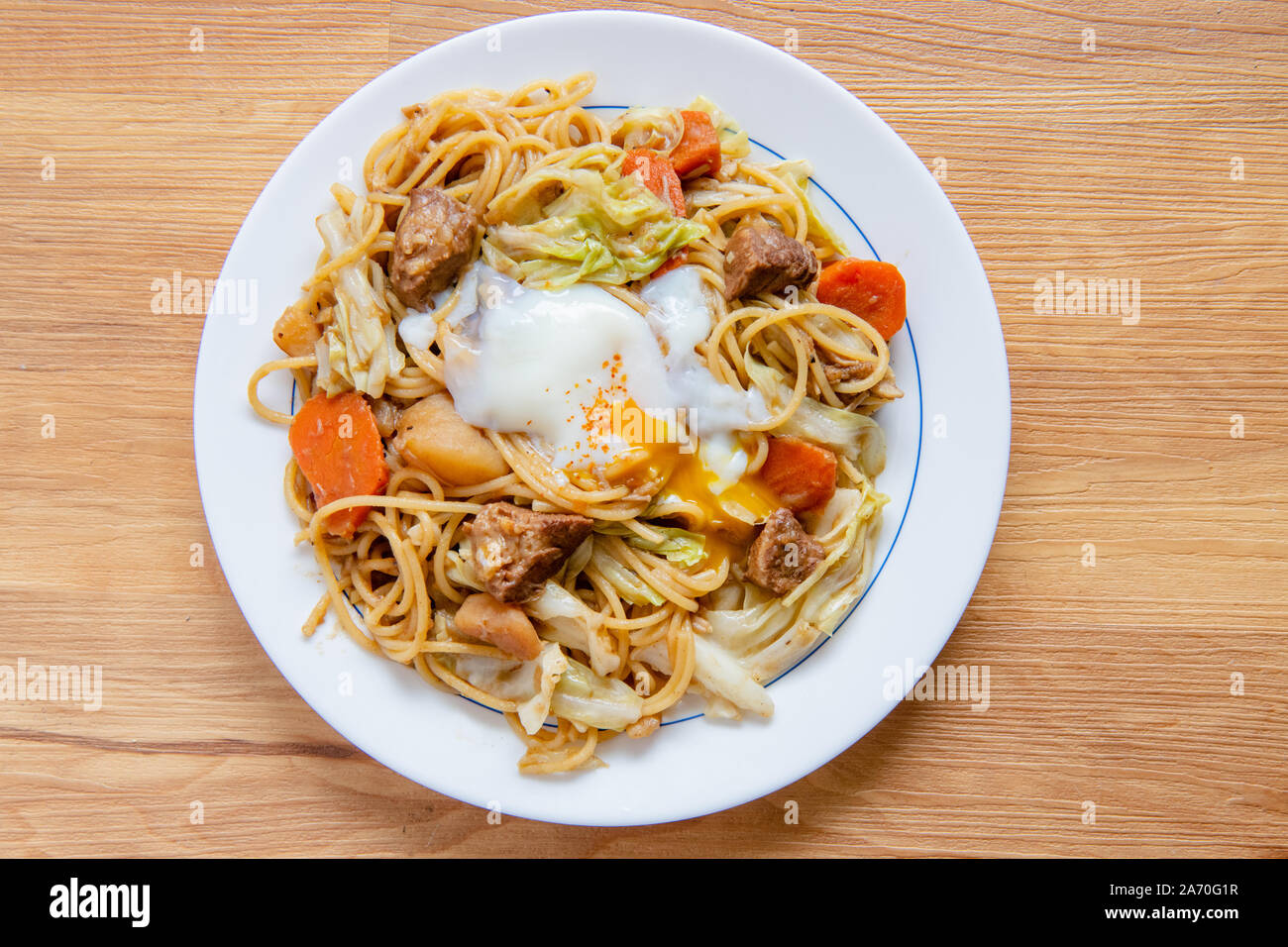 Pork Curry spaghetti on wooden background ( Onsen tamago, Potato, enoki ...