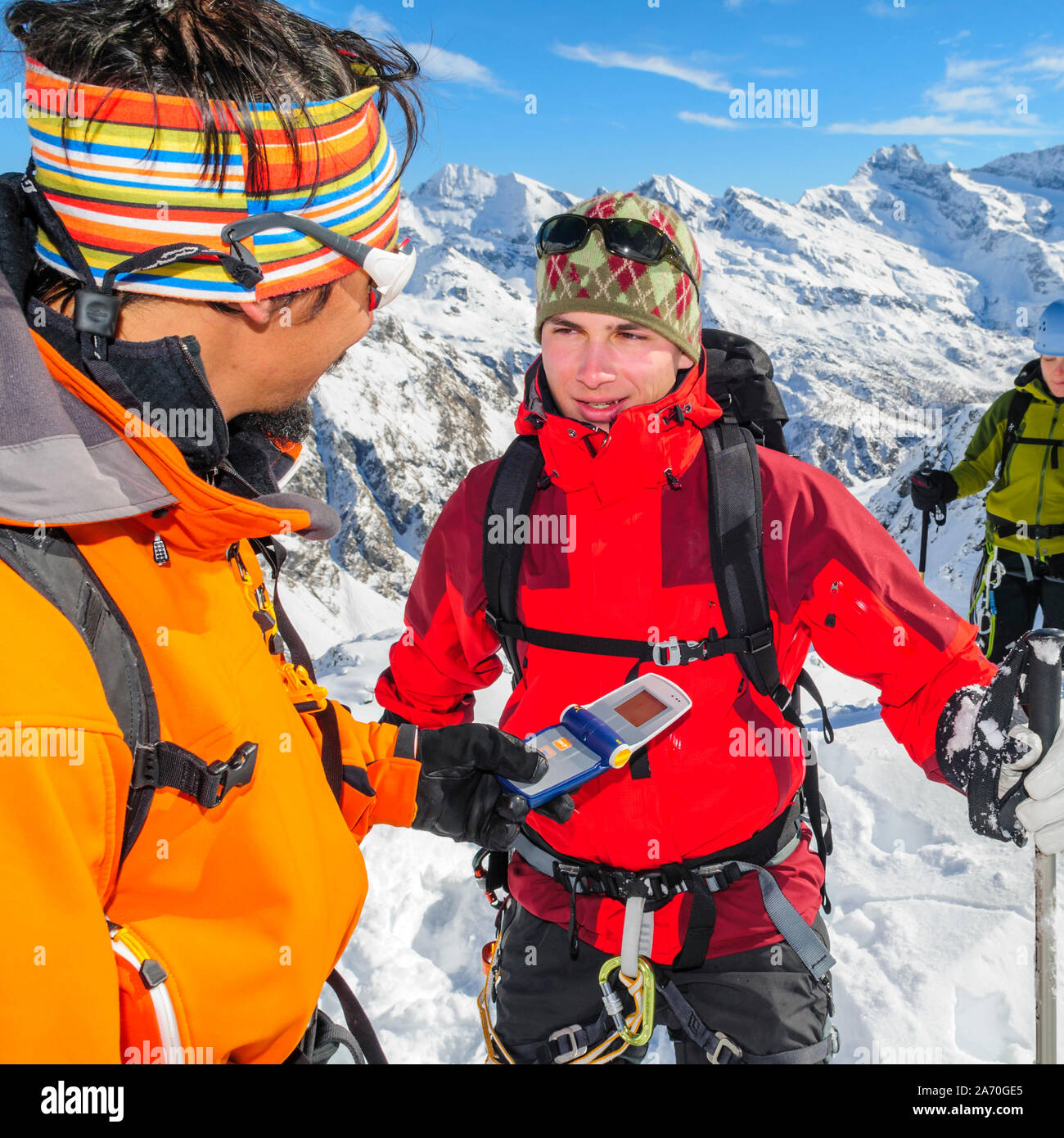 Mountain guide checking functionality of safety equipment Stock Photo ...