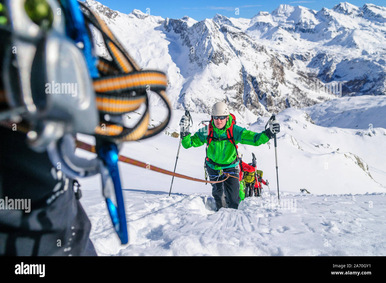 Rope team ascending to mountain top in high alpine region in winter ...