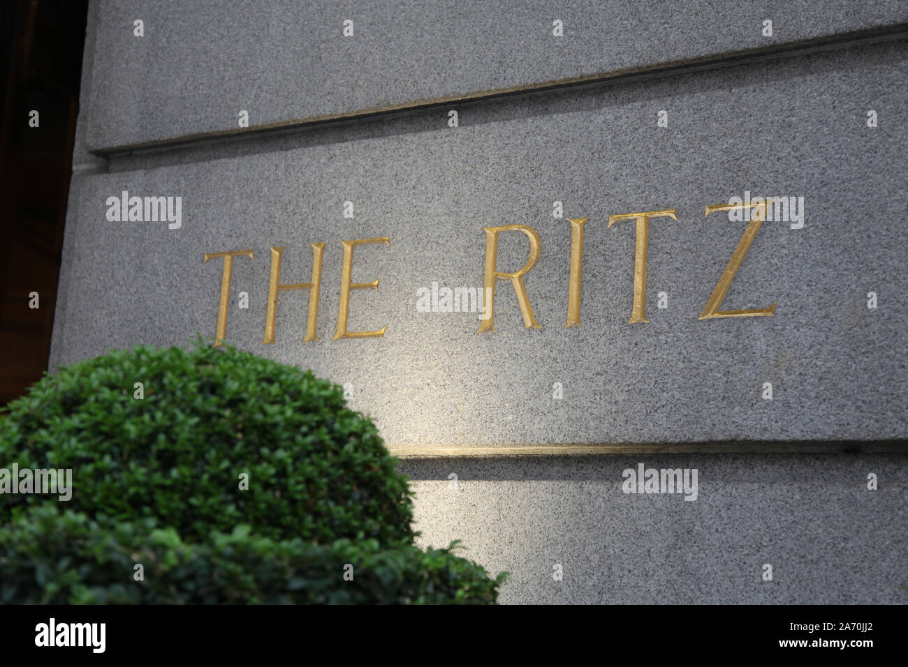 Golden letters of The Ritz hotel engraved in to marble wall on ...