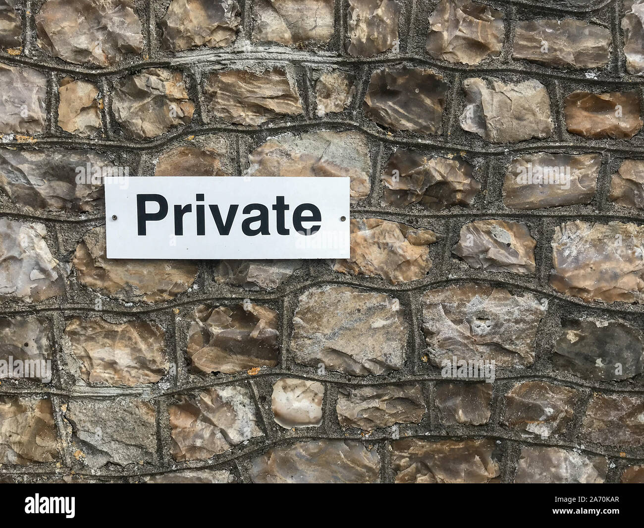 A small private sign black text on a white background attached to a ...