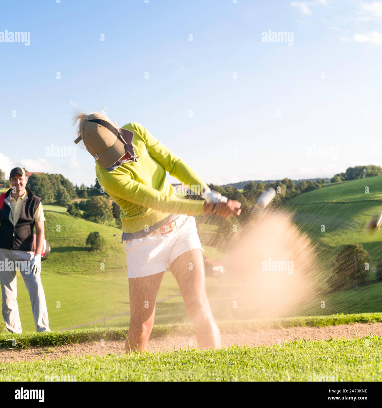 Playing golf in bavarian Allgäu at a sunny late afternoon in summertime ...
