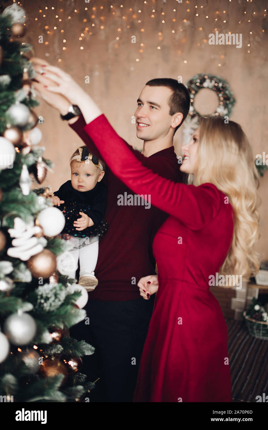 Beautiful family decorating Christmas tree together.Christmas tree ...