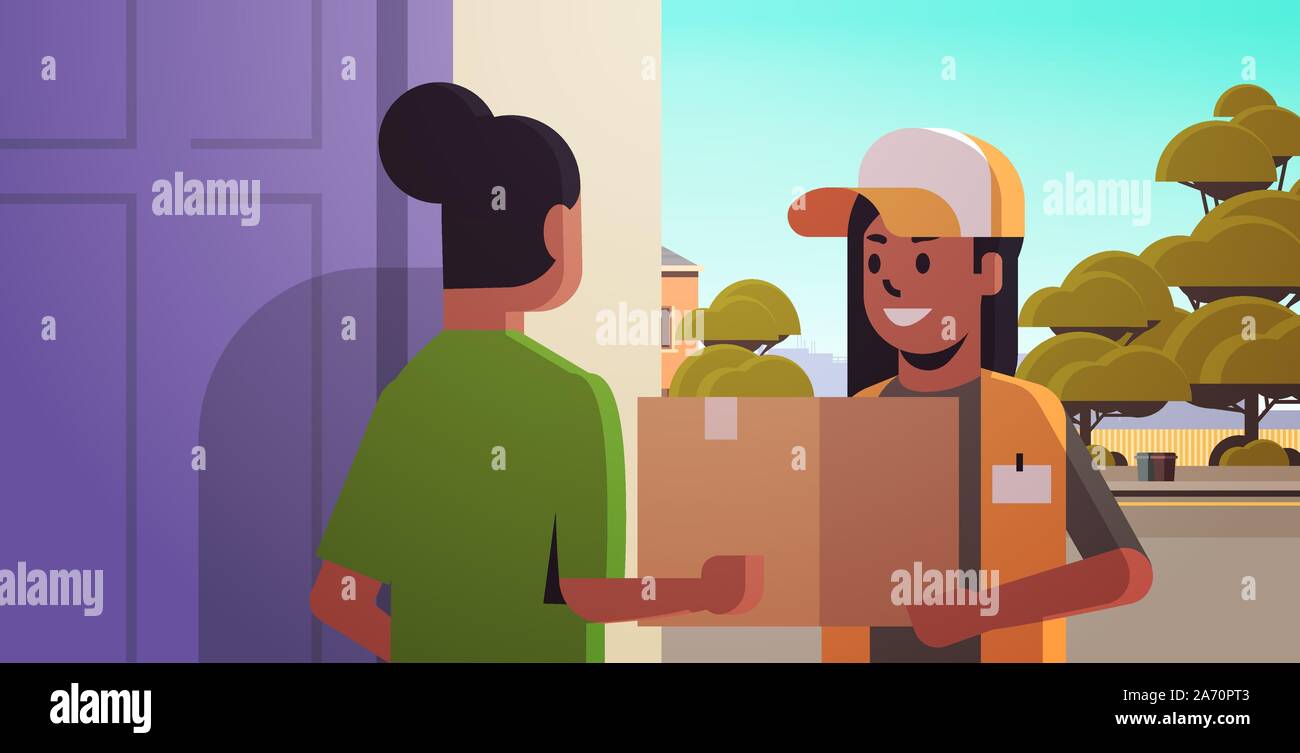 courier woman delivering cardboard parcel box to african american girl ...