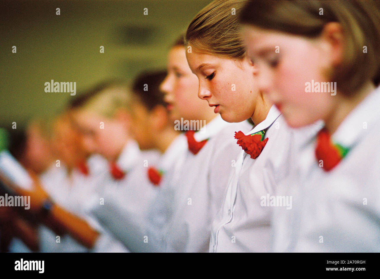 Children. Close up of teenage schoolgirls singing at assembly Stock ...