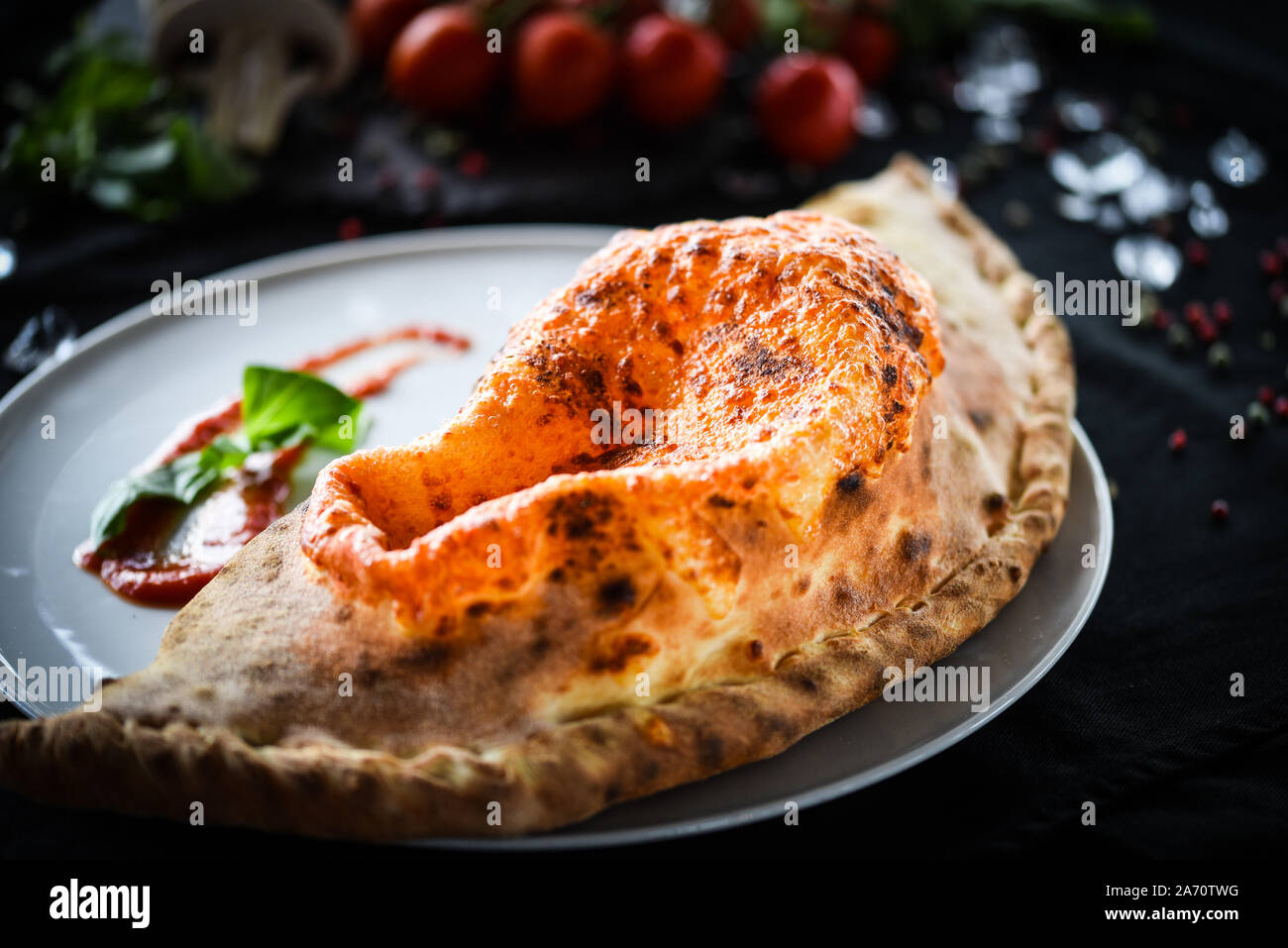 tasty italian calzone pizza dish with fresh ingredients Stock Photo - Alamy