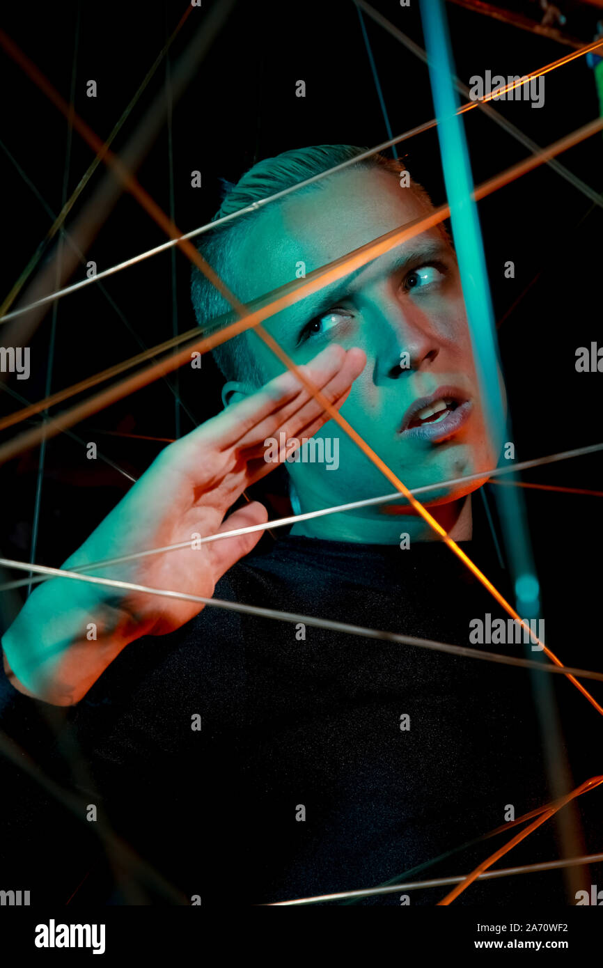 a teenager at a party got tangled up among the ropes. young man in ...