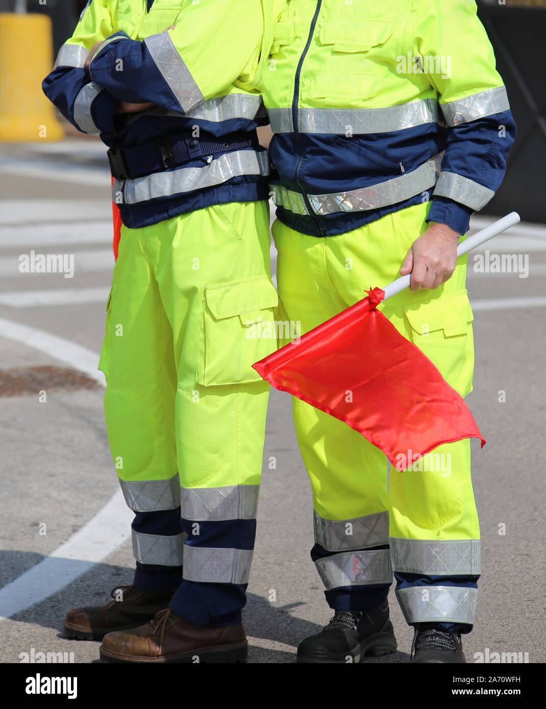 men of the Italian civil protection with uniform and the red flag to ...