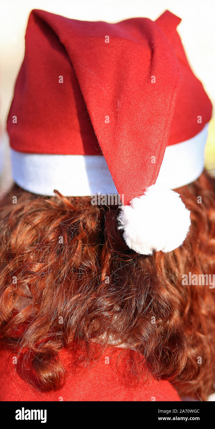 girl with long red hair with a red cap on his head and the costume of ...