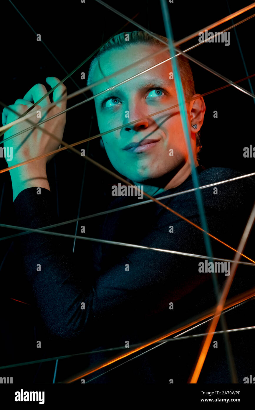 a teenager at a party got tangled up among the ropes. young man in ...