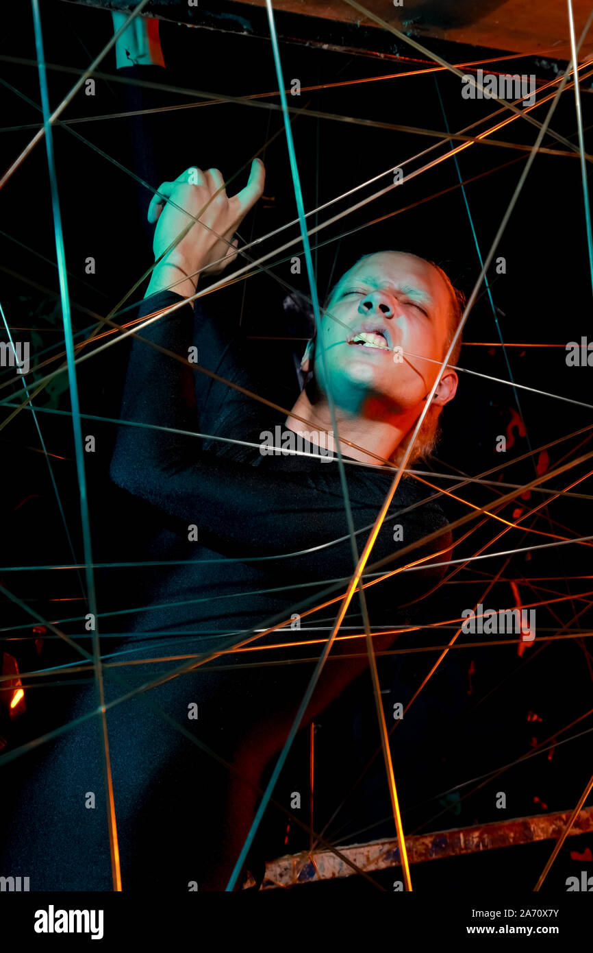 a teenager at a party got tangled up among the ropes. young man in ...