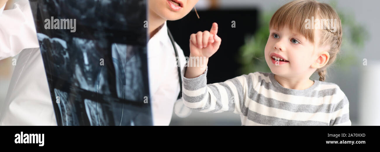 Little child girl with medical doctor look at x-ray image Stock Photo ...