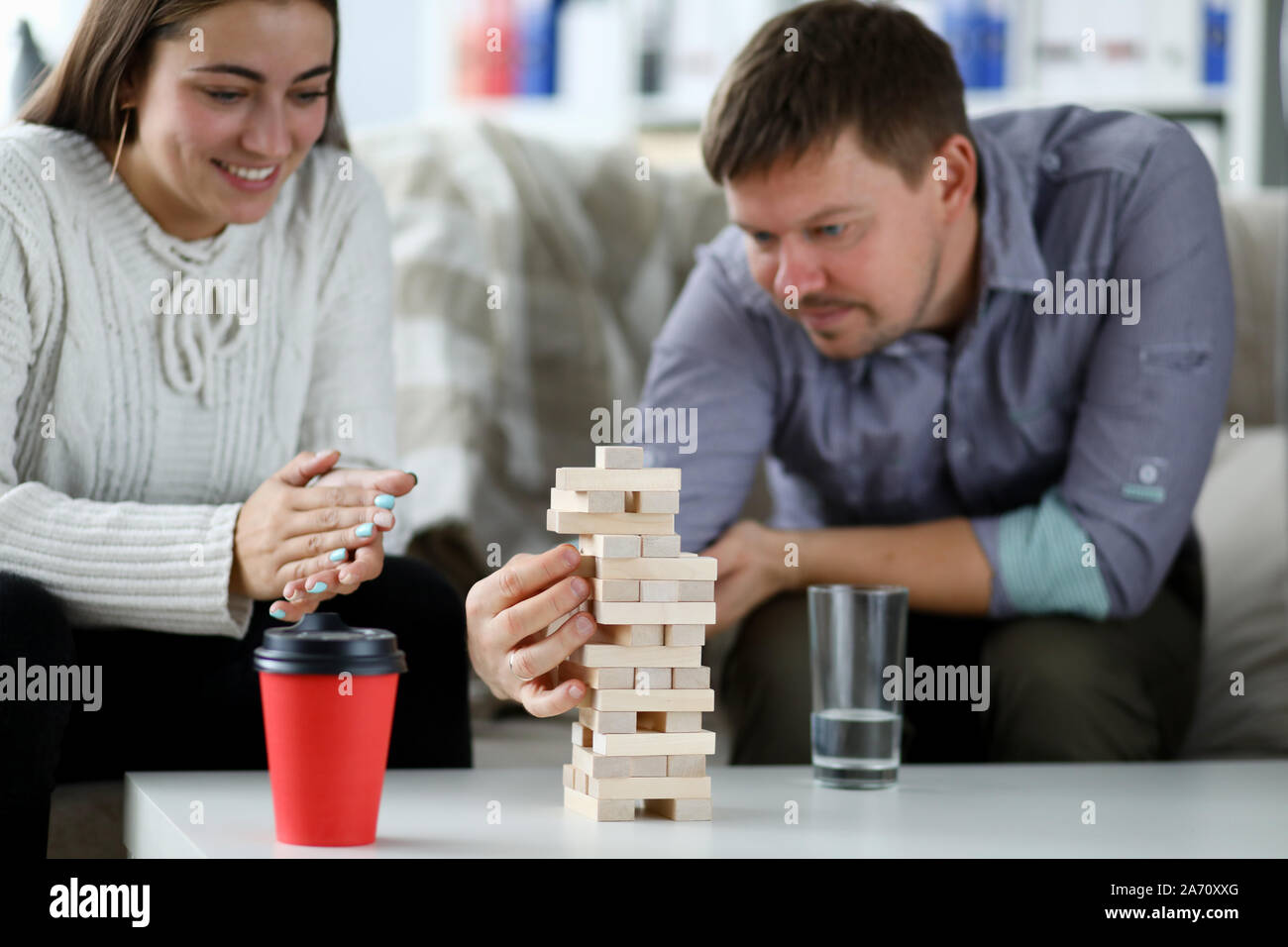 Couple build tower from wood block Stock Photo - Alamy