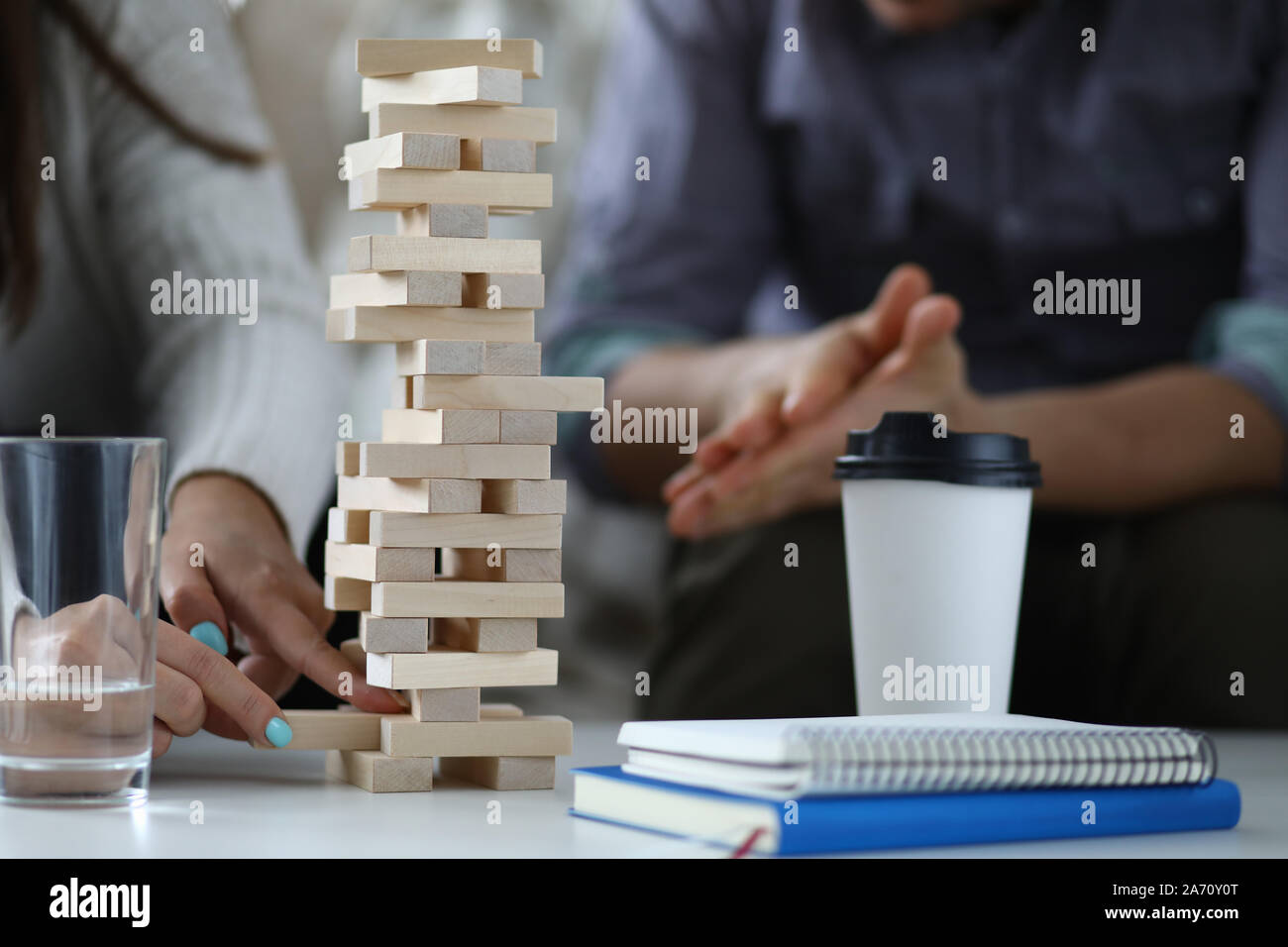Couple build tower from wood block Stock Photo - Alamy