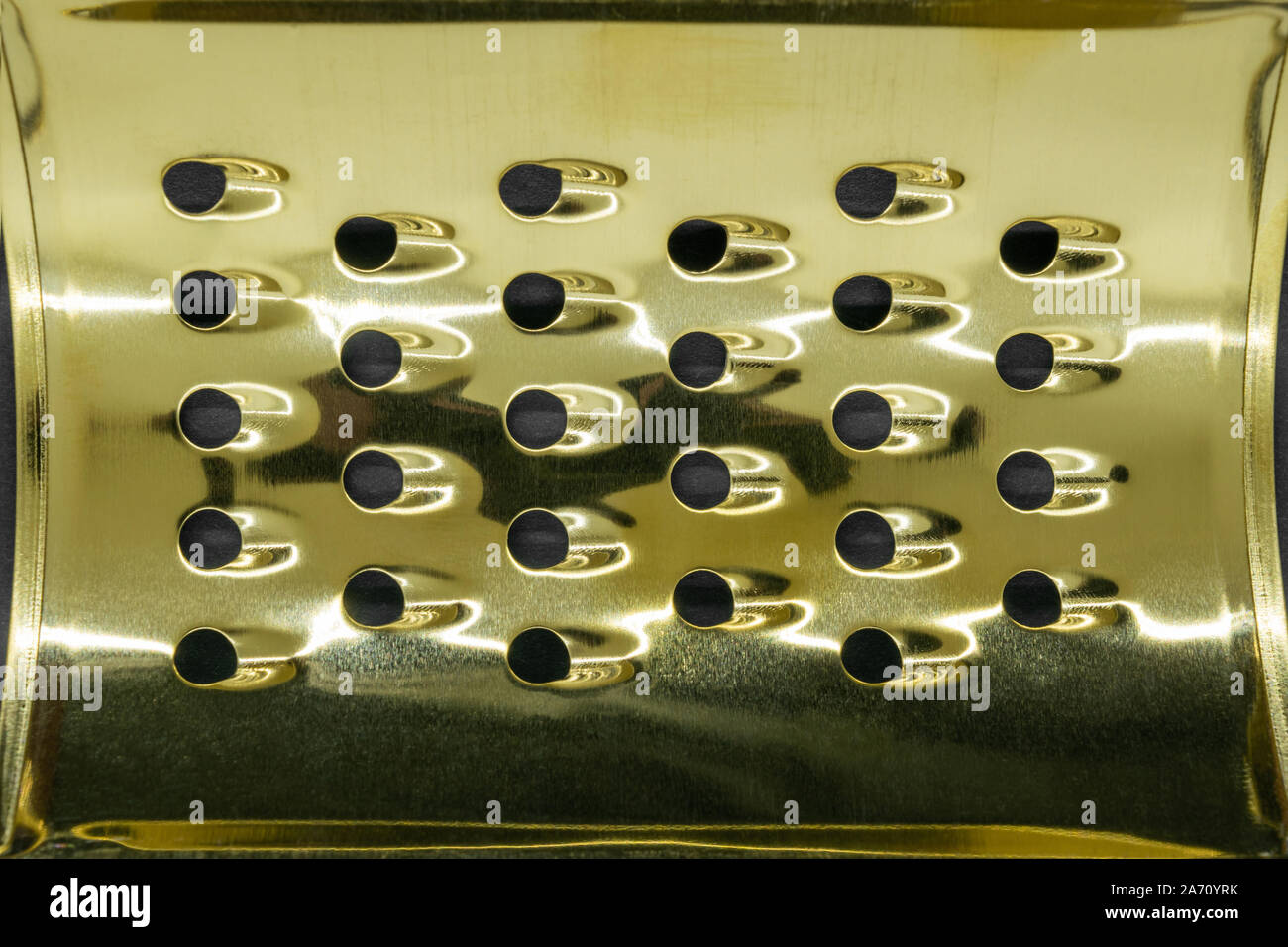 Inner side background of golden shiny hand grater with holes Stock ...