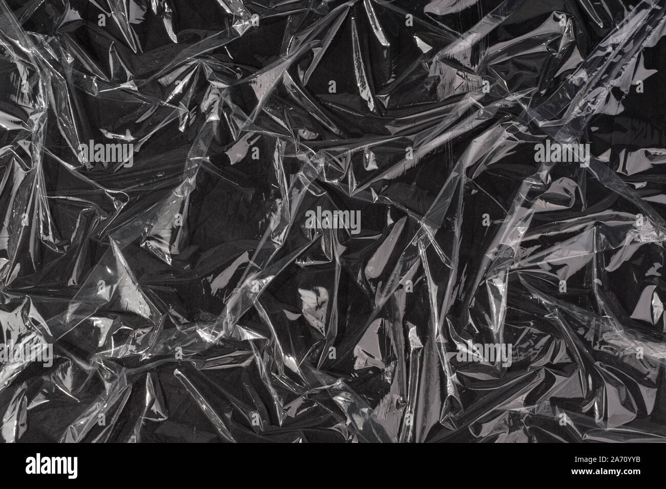Transparent plastic foil on black background Stock Photo - Alamy