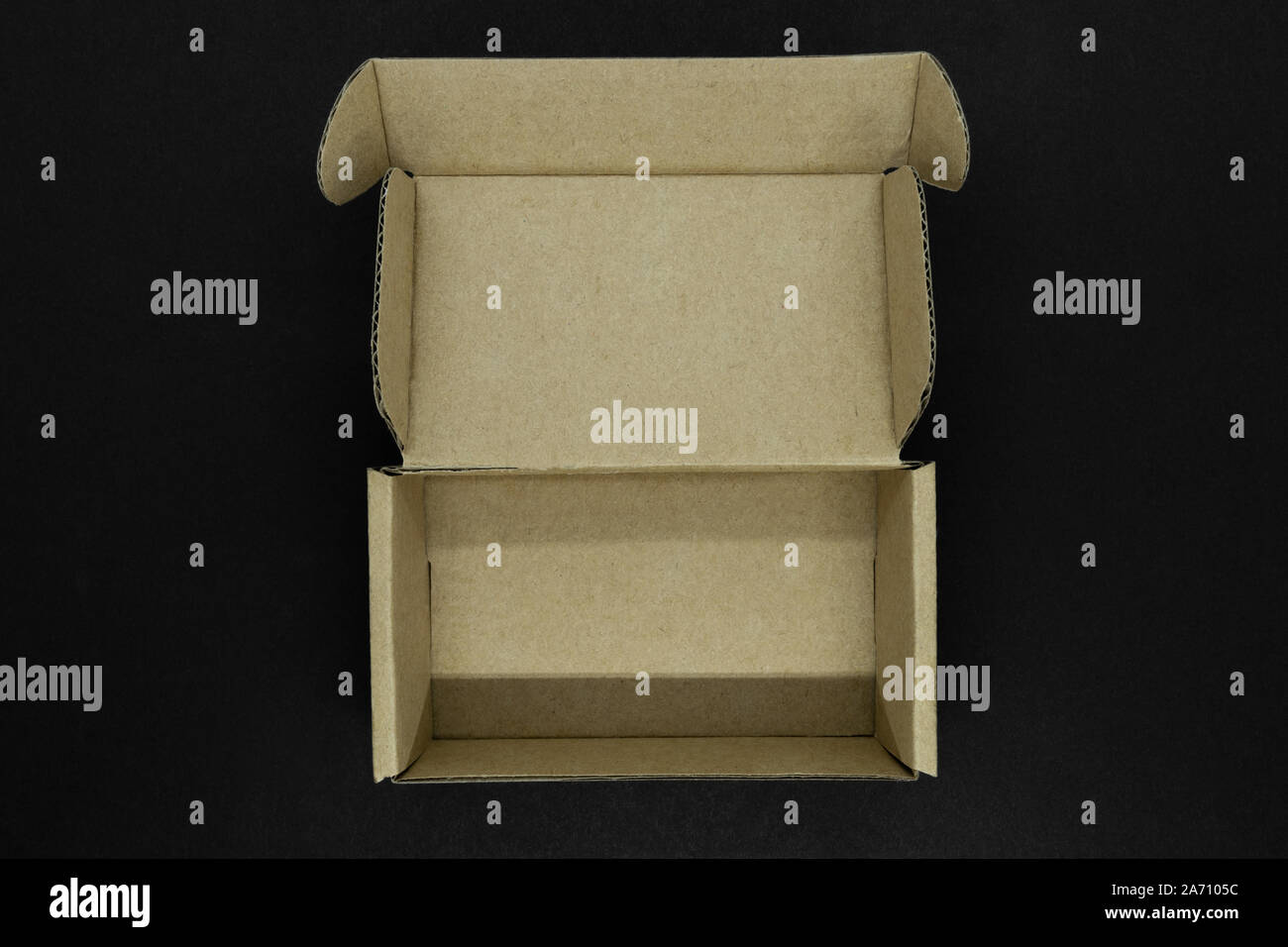 Top view of opened cardboard rectangle box on matte black background ...