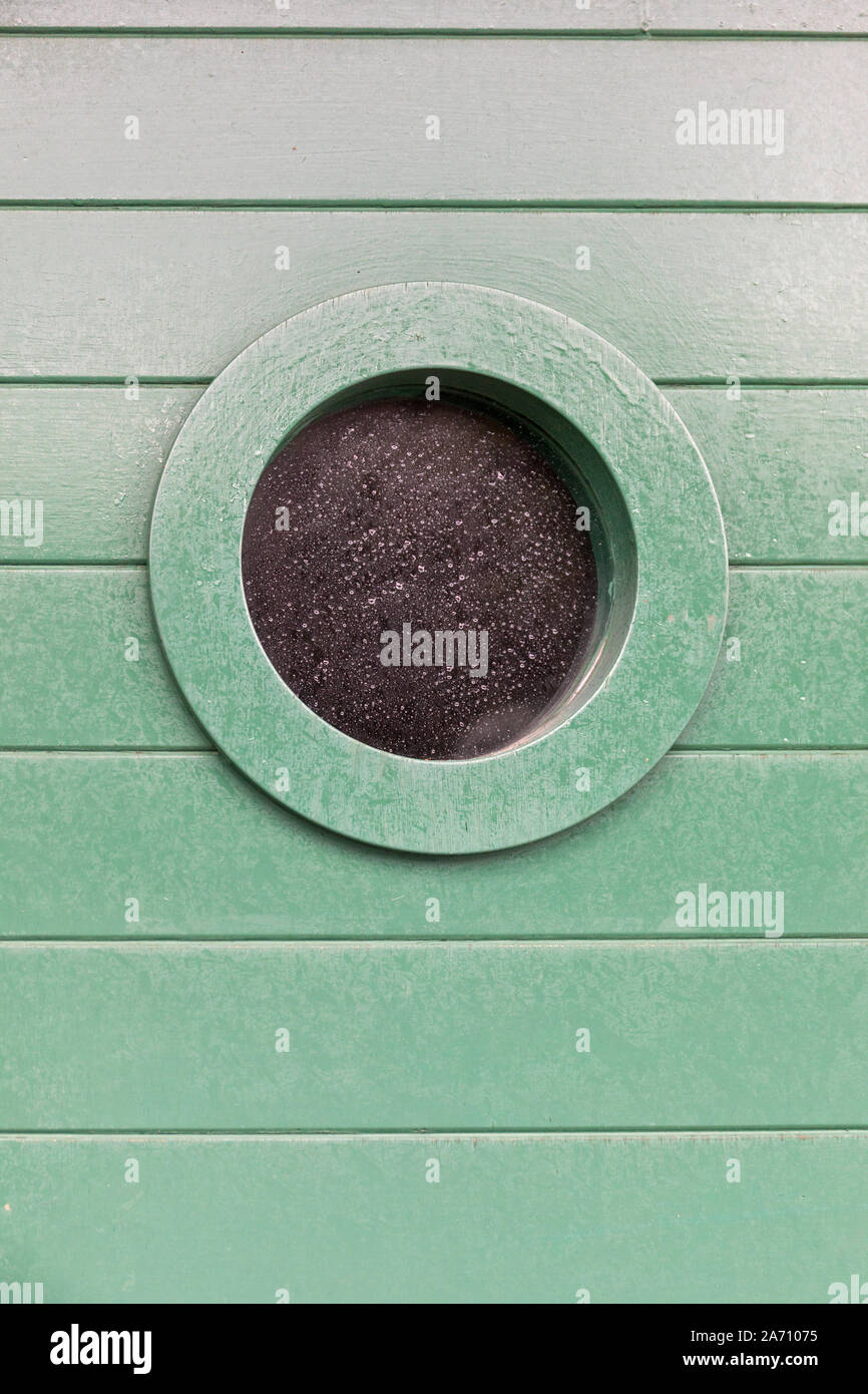 One Round Window at Green Wood Cabin Stock Photo - Alamy