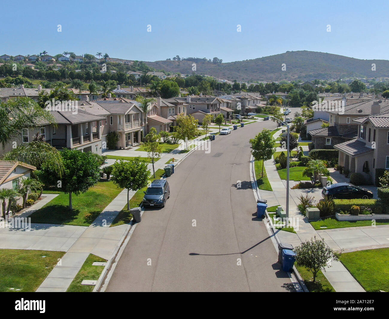 Suburban neighborhood street with big villas next to each other in ...