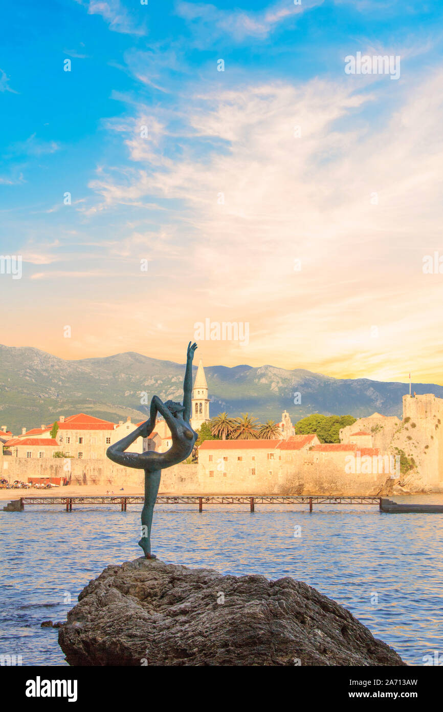Beautiful view of the sculpture Ballerina Dancer of Budva at sunset ...