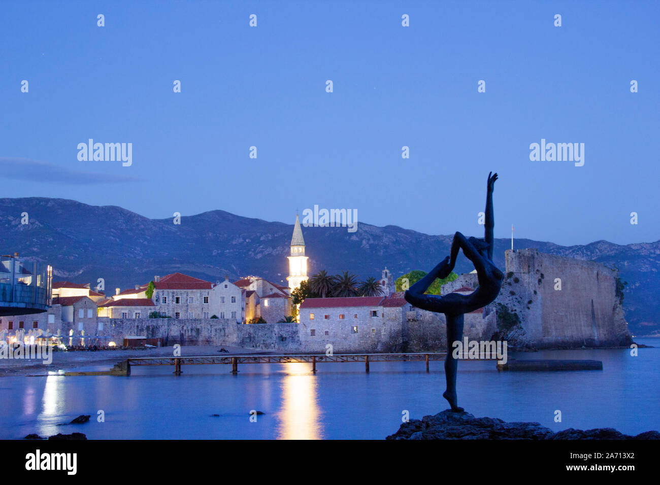 Beautiful view of the sculpture Ballerina Dancer of Budva at sunset ...