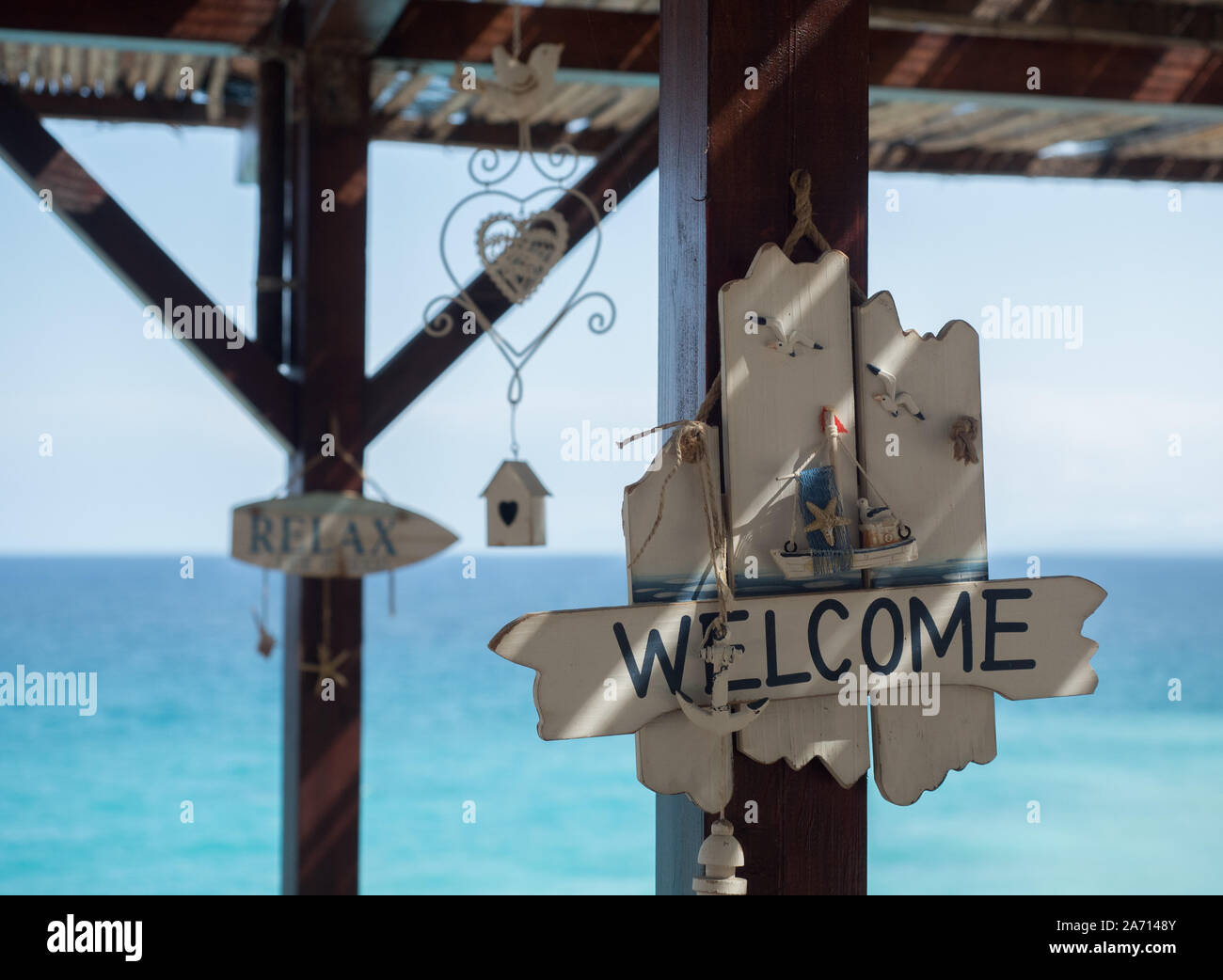 WELCOME sign in a bar at the seaside Stock Photo - Alamy