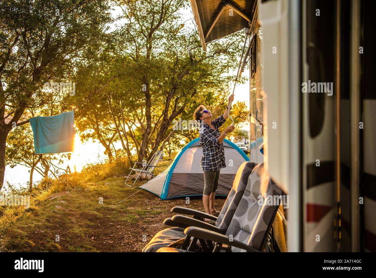 Caucasian Retired Woman in Her 60s Extending RV Awning at RV Park ...