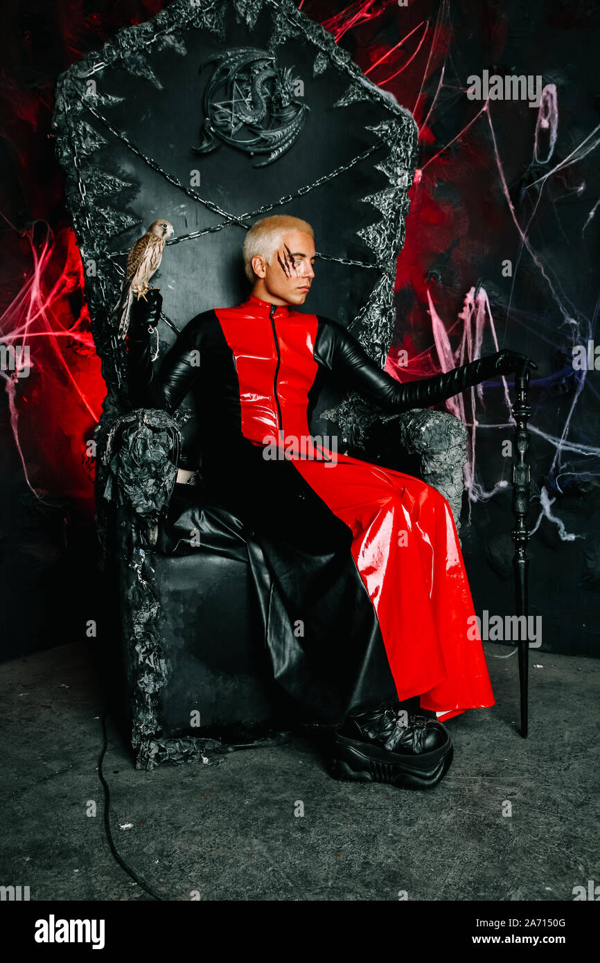 Gothic man with scary bloody makeup and bird of prey on huge scary ...