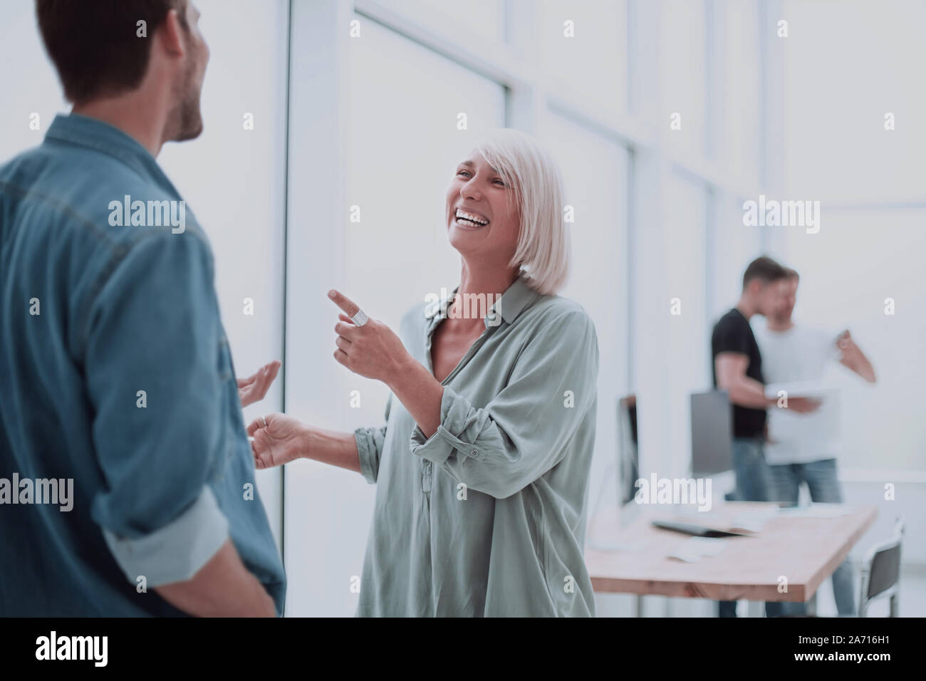 smiling businesswoman explaining something to her colleague Stock Photo ...