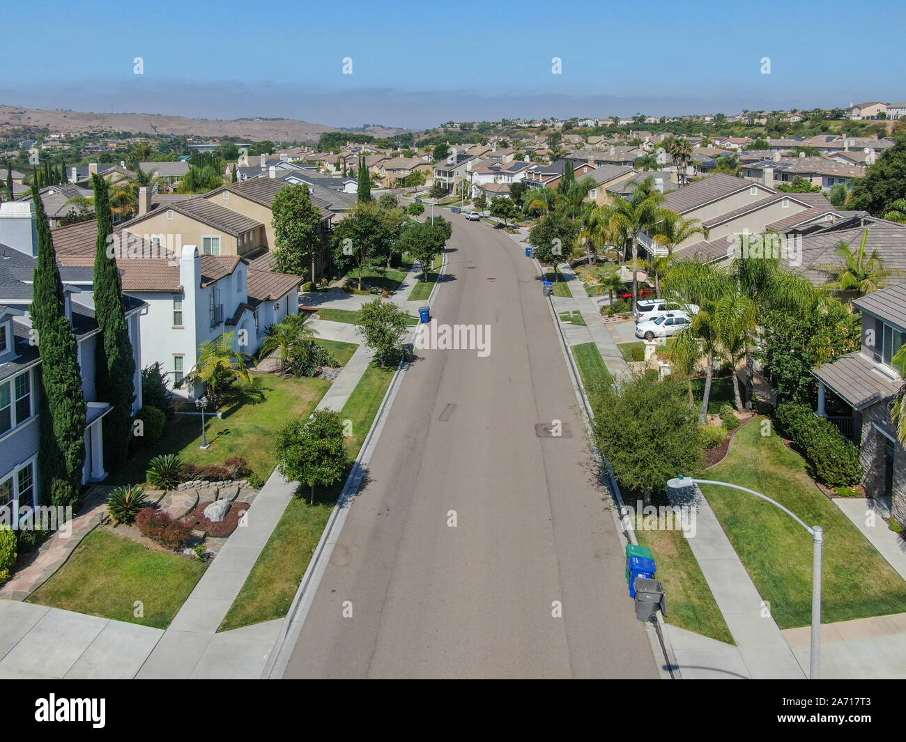 Suburban neighborhood street with big villas next to each other in ...