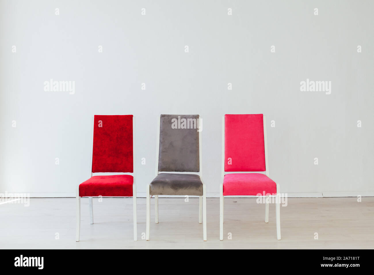 three vintage chairs in an empty white room Stock Photo - Alamy